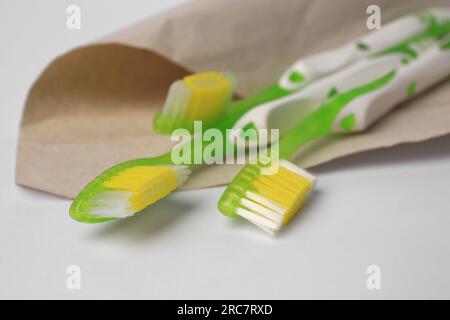 Light green toothbrushes on white background, space for text Stock ...