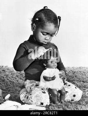 Los Angeles, California: 1974 A young girl holds her talking Rodney ...