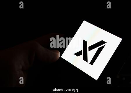 xAI company logo seen on the screen. Elon Musk created artificial ...