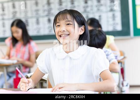 Elementary school students studying during class Stock Photo - Alamy