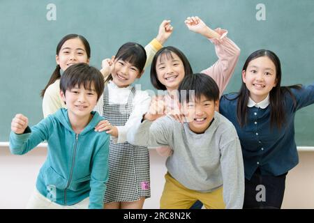 Elementary school children playing in front of the blackboard Stock ...