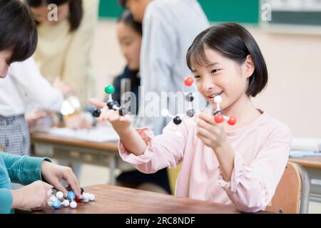 Elementary school students assembling a model in the classroom Stock ...