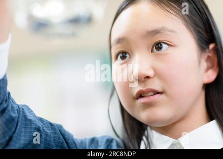 Elementary school students conducting experiments in the classroom ...