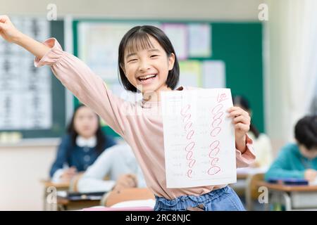 Elementary School Student Holding Test and Smiling Stock Photo - Alamy