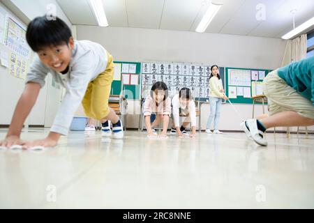 Elementary school students dusting the classroom floor Stock Photo - Alamy