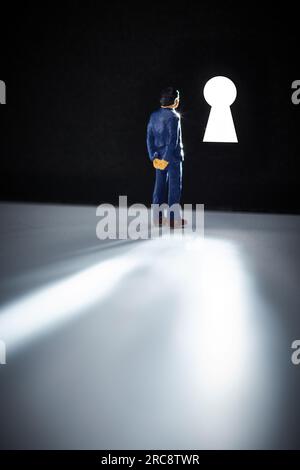 Keyhole and miniature man Stock Photo - Alamy