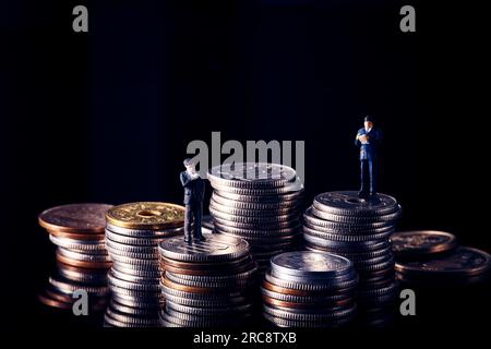 Miniature of a working man with several piles of Japanese money Stock ...