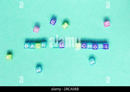 The inscription back to school made by multicolor plastic cubes on a ...