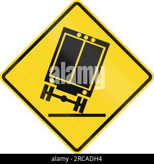 Canadian road warning sign - Trucks may tip over on curve. This sign is ...