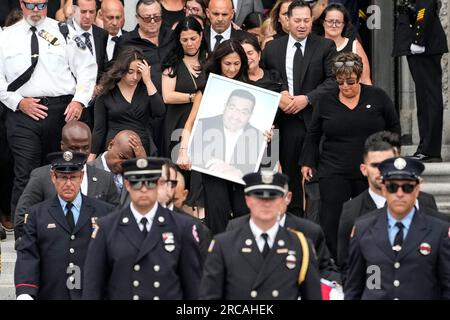 The casket of Newark firefighter Augusto "Augie" Acabou is carried from ...