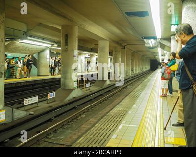Train coming when people waiting for transportation, TACHiKAWA Japan ...