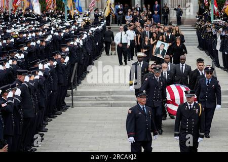 The casket of Newark firefighter Augusto "Augie" Acabou is raised to ...