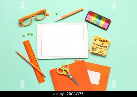 Sticky notes with word HOMEWORK, tablet and different stationery on ...