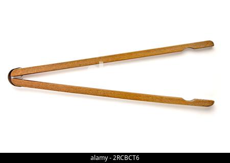 Shabby old wooden tongs for boiling hot washing clothes isolated on ...