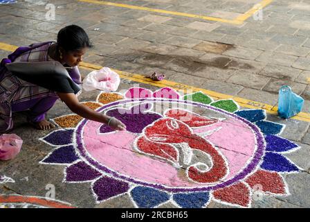 Drawing kolam, rangoli inside the temple floor, Sri Neelayadhakshi ...