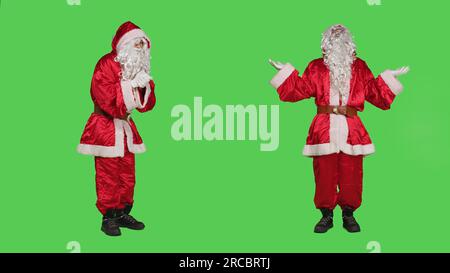 Santa claus character praying to god in studio, wearing famous red ...