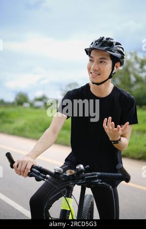 Handsome cyclist having break during morning ride outdoors Stock Photo ...