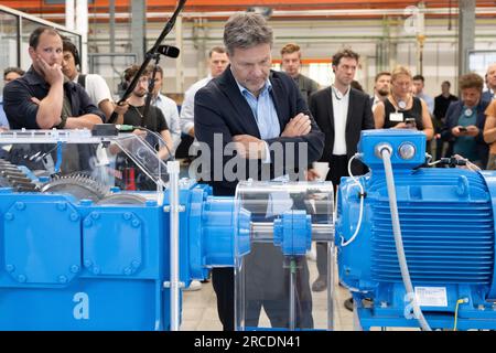 Penig, Germany. 14th July, 2023. A woman stands at a workbench in a ...