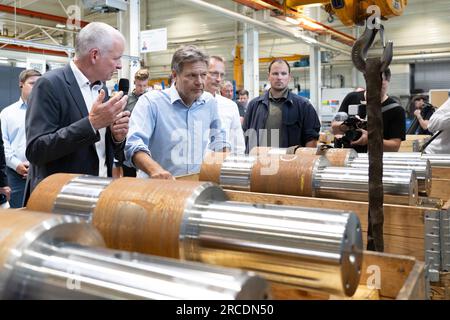 Penig, Germany. 14th July, 2023. An employee works on a gear wheel in a ...