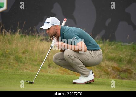 Wyndham Clark lines up a putt on the 8th green during the final round ...