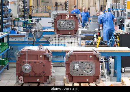 Penig, Germany. 14th July, 2023. An employee works on a gear wheel in a ...