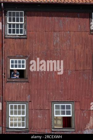 Porto, Portugal - 25 April, 2023: Man smoking in window of old red ...