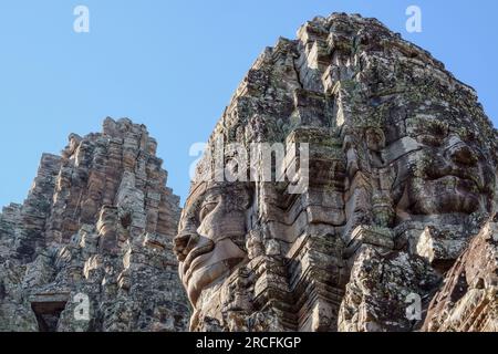 Image showcasing stone human faces on the towers of the Khmer Bayon ...