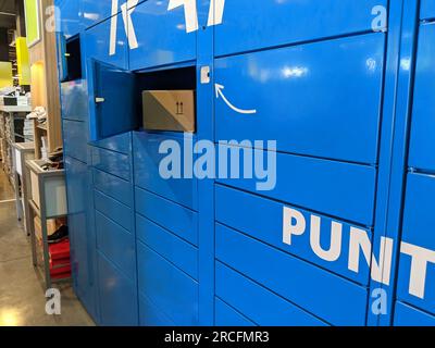 Blue parcel collection lockers in a store Stock Photo - Alamy
