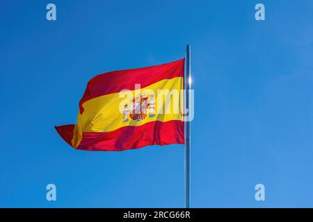spain flag on blue sky Stock Photo - Alamy