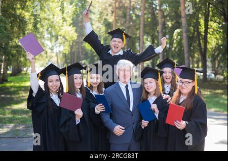 University professor and seven graduates rejoice at graduation Stock ...