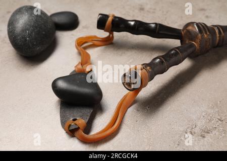 Slingshot with stones on light grey background, flat lay Stock Photo ...