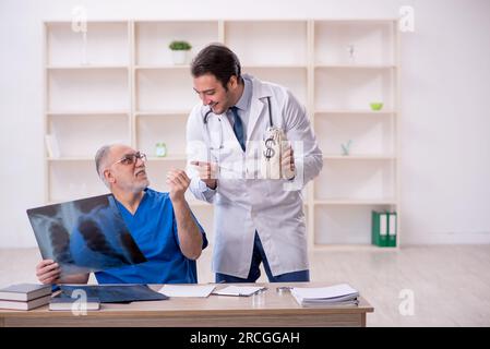 Two doctors in remuneration concept Stock Photo - Alamy