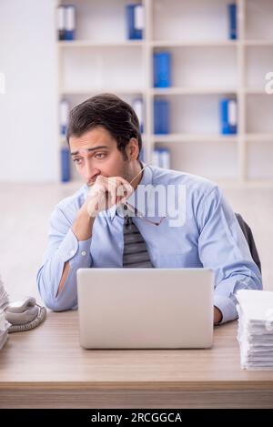Young businessman employee unhappy with excessive work Stock Photo - Alamy