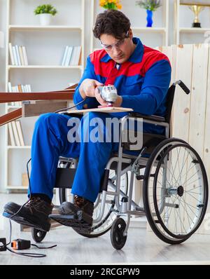 Disabled carpenter working with tools in workshop Stock Photo - Alamy