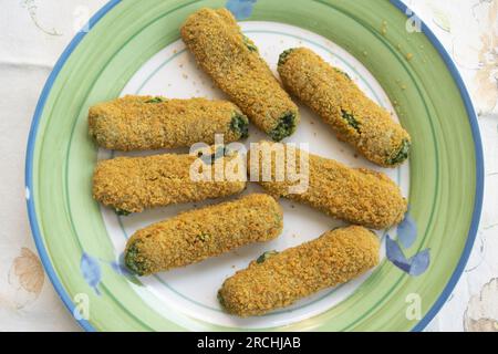 breaded spinach sticks in a dish Stock Photo - Alamy