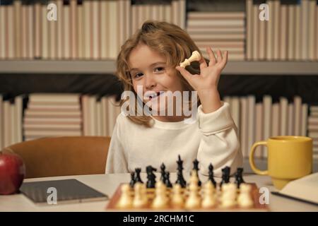 Chess game for children. Shool kid playing chess in classroom. Kids ...