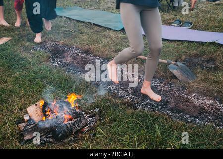 Coal walking or fire walking. Barefoot person on burned wood and hot ...