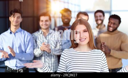 team clapping to the leader woman in the foreground Stock Photo - Alamy