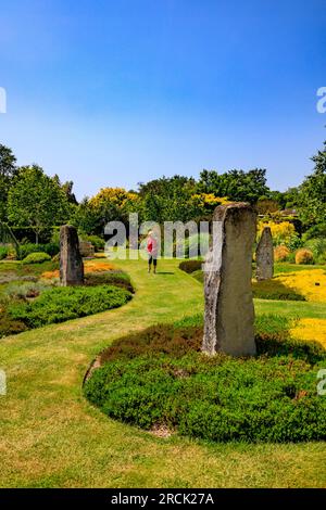 A lady visitor wandering around the ‘Holme Henge’ Purbeck stone ...