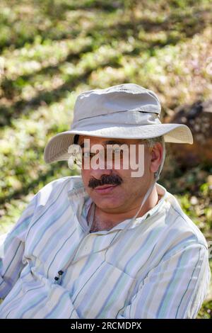 arabic man with a hat and a moustache enjoying with family and friends ...