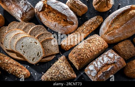 Assorted bakery products including loafs of bread and rolls Stock Photo ...