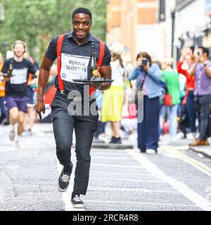 The winner of the Soho Waiters’ Race approaches the finish line. An ...