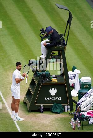 Chair Umpire, Fergus Murphy speaking with Novak Djokovic during the ...