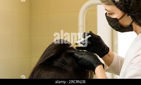 Esthetician uses thin needle to inject Platelet-Rich Plasma in scalp ...
