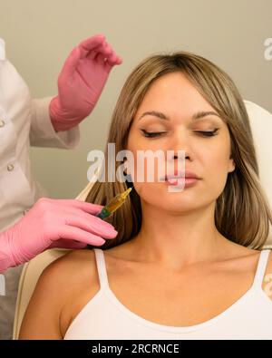 Esthetician uses thin needle to inject Platelet-Rich Plasma in skin ...