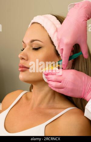 Esthetician uses thin needle to inject Platelet-Rich Plasma in skin ...