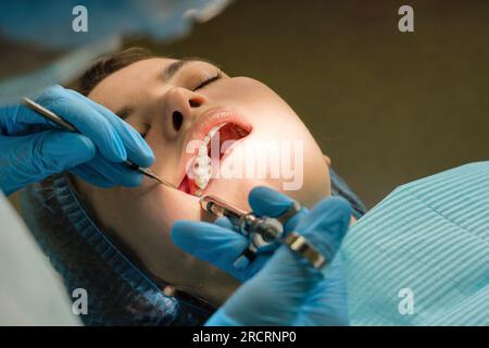 Dental surgeon performs conduction anesthesia with lidocaine using a ...