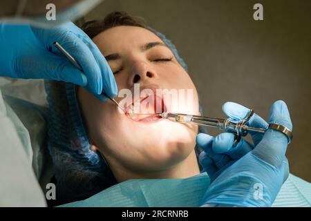 Dental surgeon performs conduction anesthesia with lidocaine using a ...