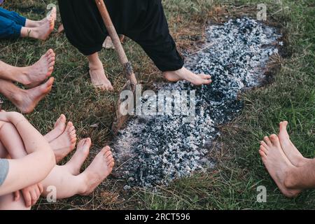 Coal walking or fire walking. Barefoot person on burned wood and hot ...