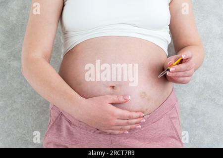 Pregnant woman making injection in stomach Stock Photo - Alamy